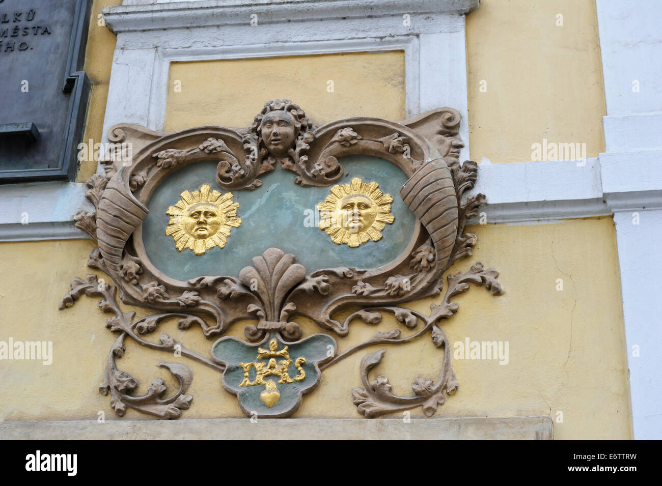 Historic house sign with sun faces on wall outside a building, Prague ...