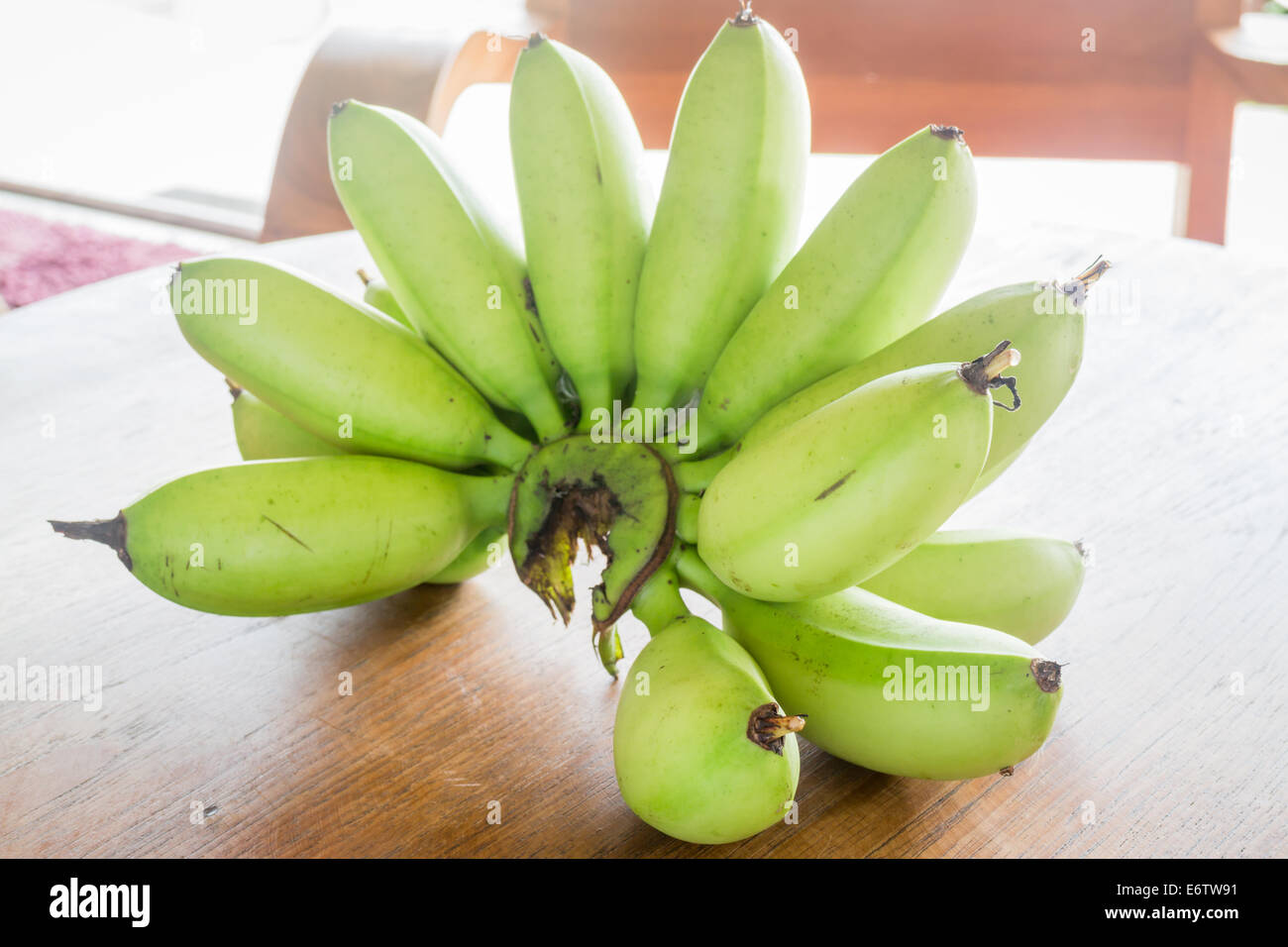 Green banana on wooden table, stock photo Stock Photo - Alamy