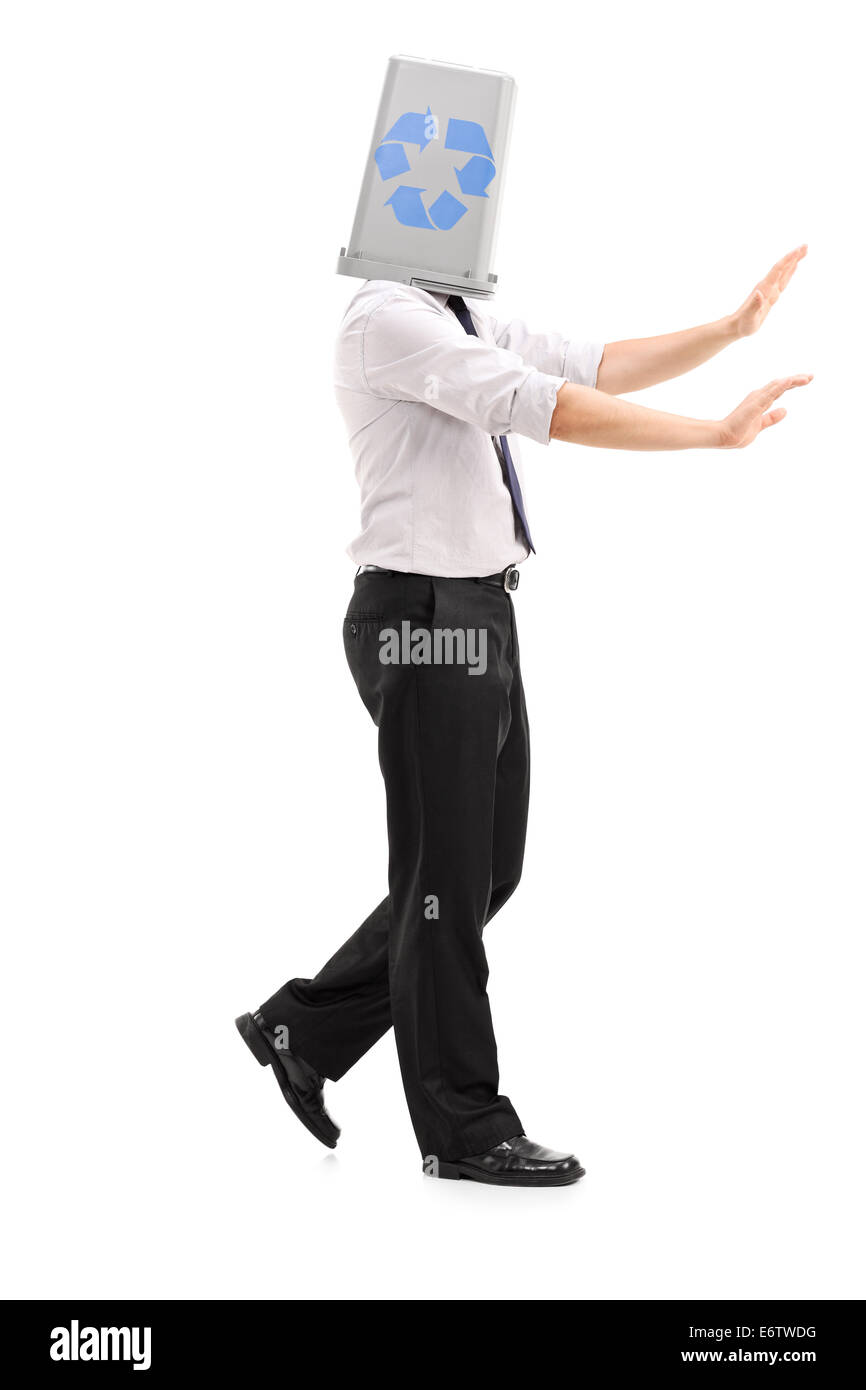 Lost man with a recycle bin over his head isolated on white background ...