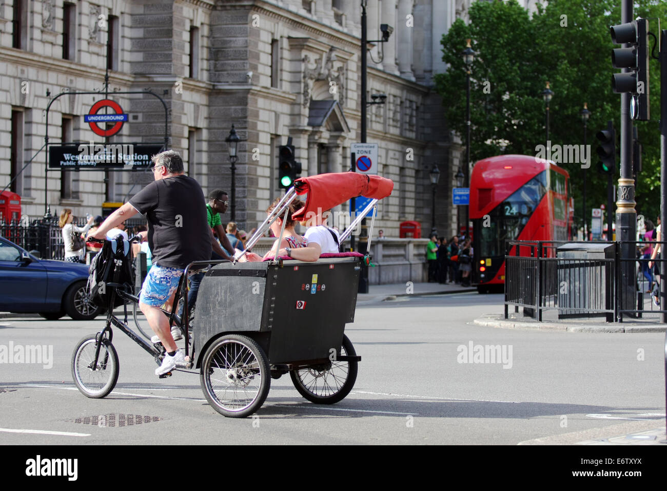 A cycle cab waiting to turn right on a road in Westminster, London ...