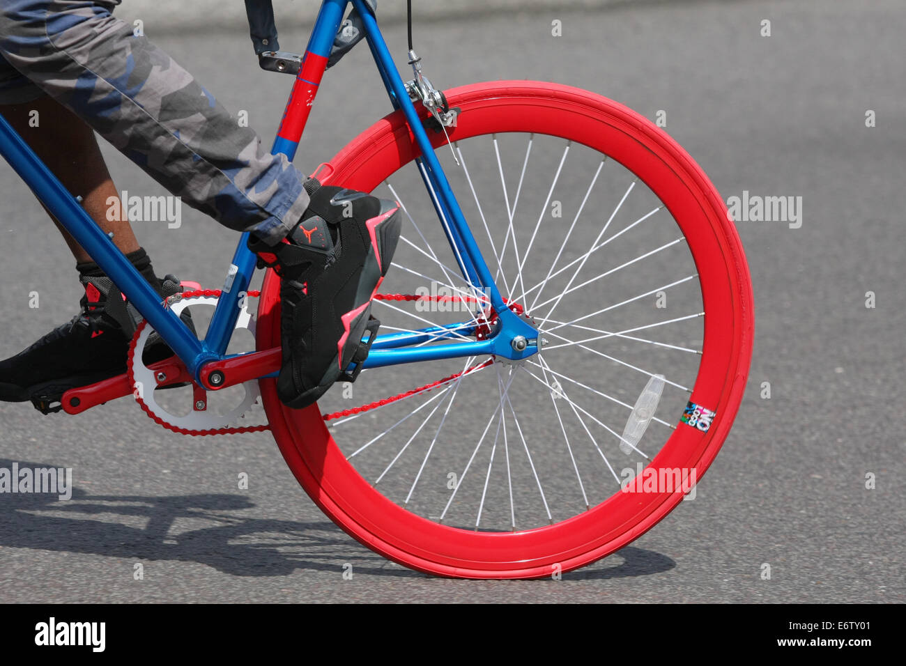 Part of a cycle and its rider, riding along a road in London Stock ...