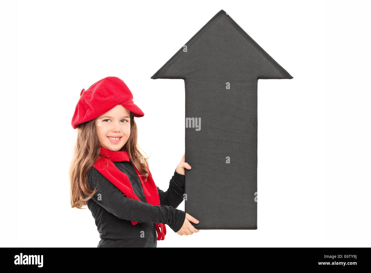 Fashionable little girl holding a big arrow pointing up Stock Photo - Alamy