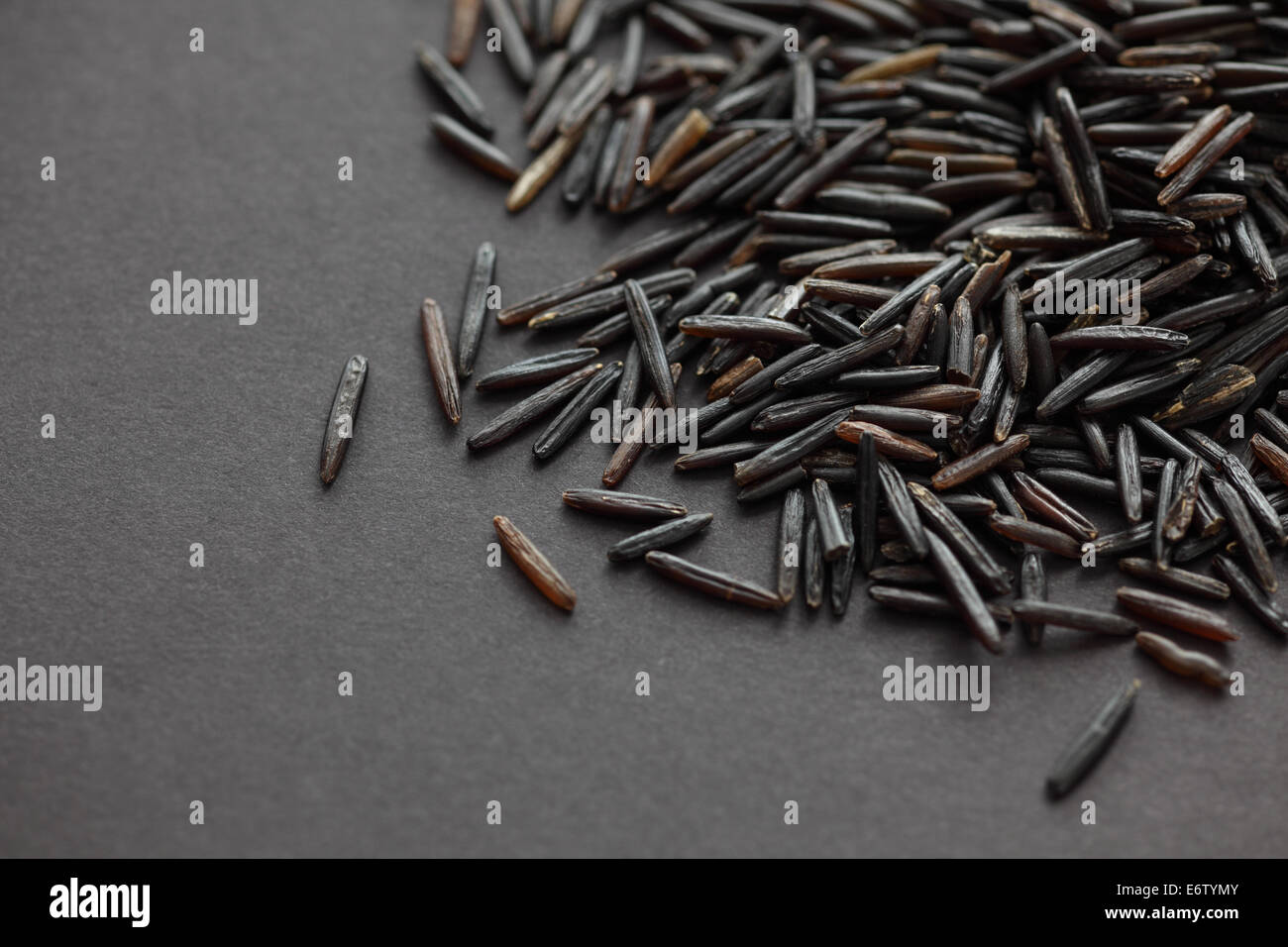 Wild Rice on black background. Closeup Stock Photo - Alamy