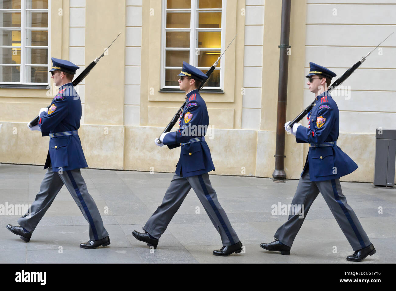Three soldiers marching with riffles on shoulders in the courtyard of ...
