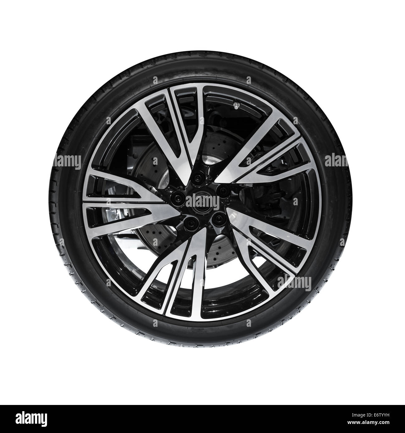 Photo of new automotive wheel on black disc isolated on white ...