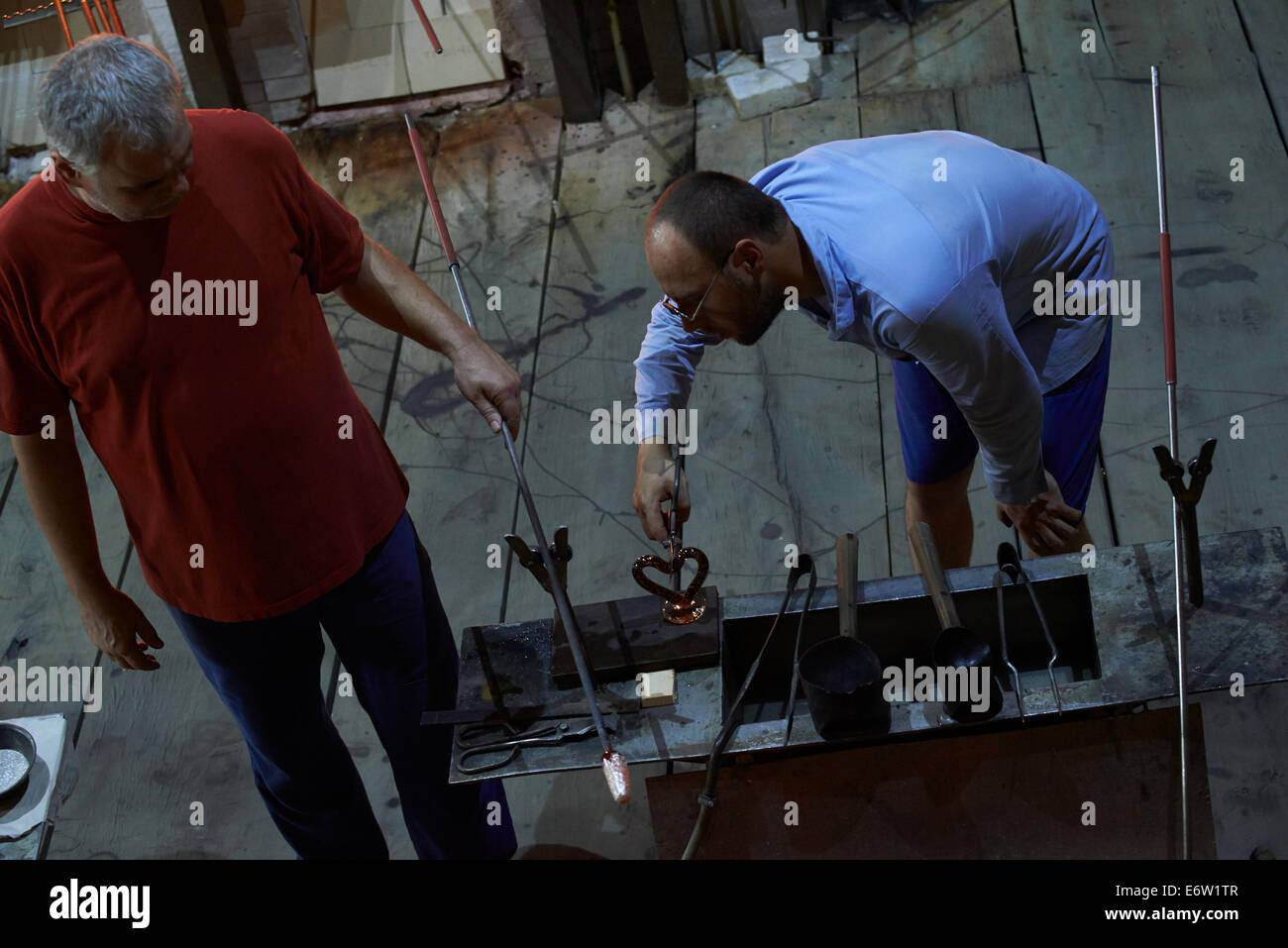 Glassmakers, Glassblowers forming molten glass, glass factory, Ajeto ...