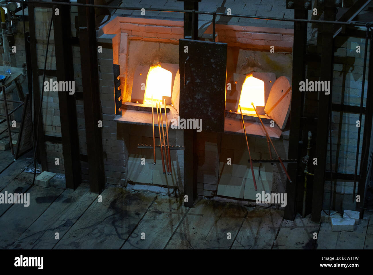 Glassmakers, Glassblowers forming molten glass, glass factory, Ajeto ...