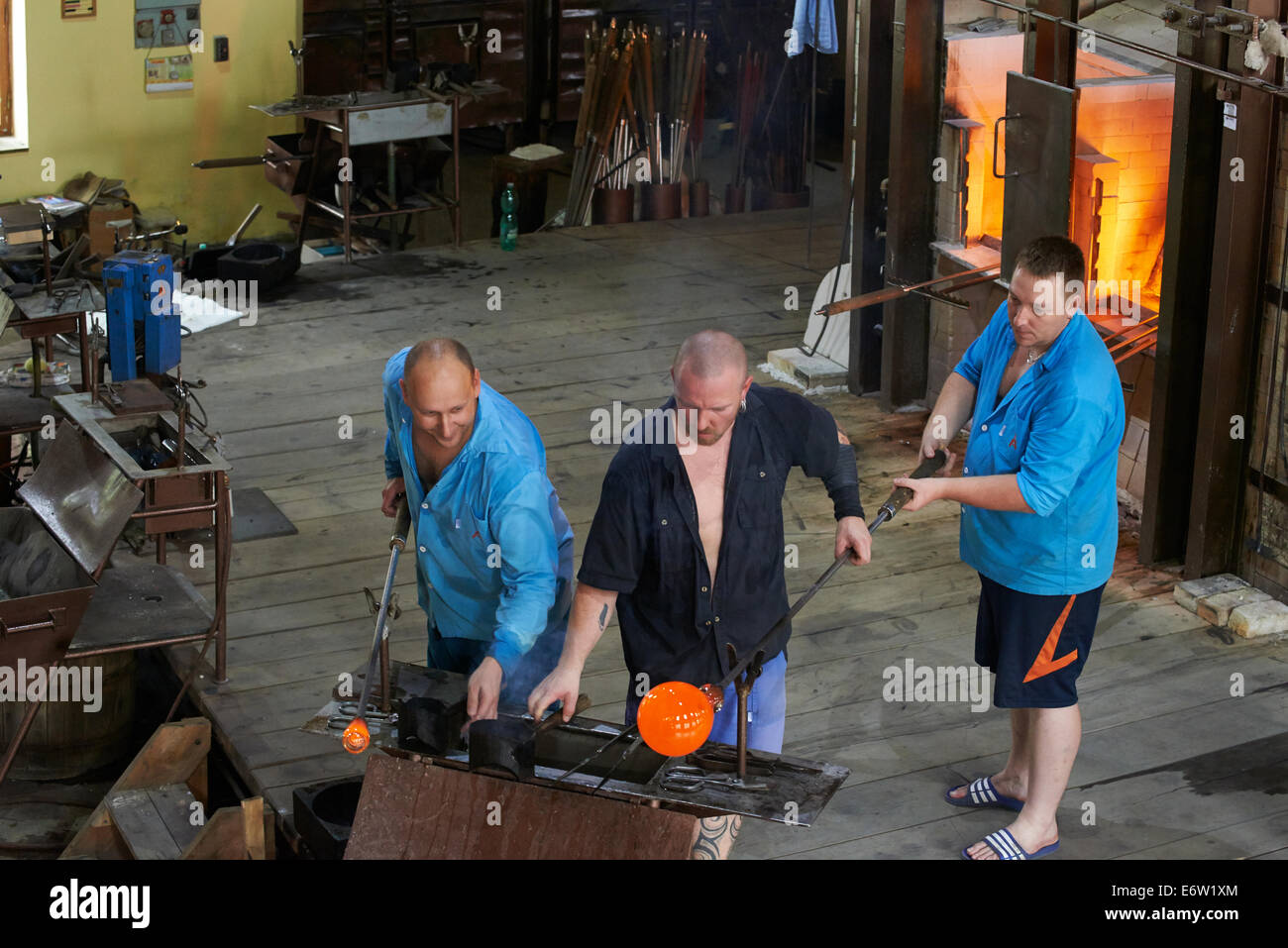 Glassmakers, Glassblowers forming molten glass, glass factory, Ajeto ...