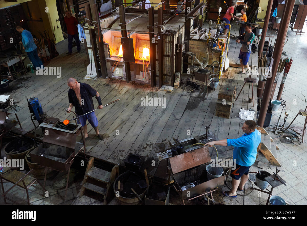 Glassmakers, Glassblowers forming molten glass, glass factory, Ajeto ...