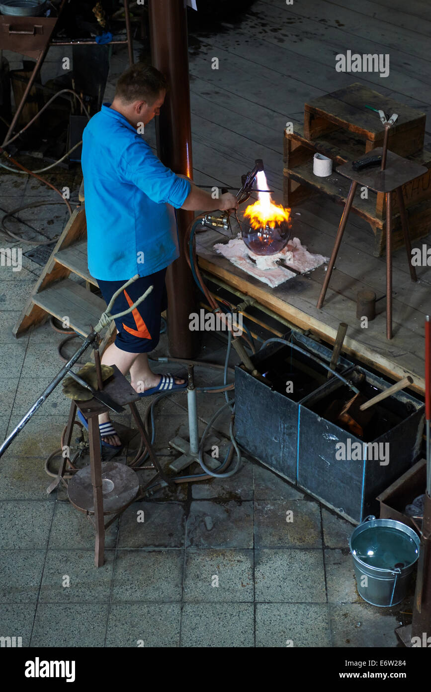 Glassmakers, Glassblowers forming molten glass, glass factory, Ajeto ...