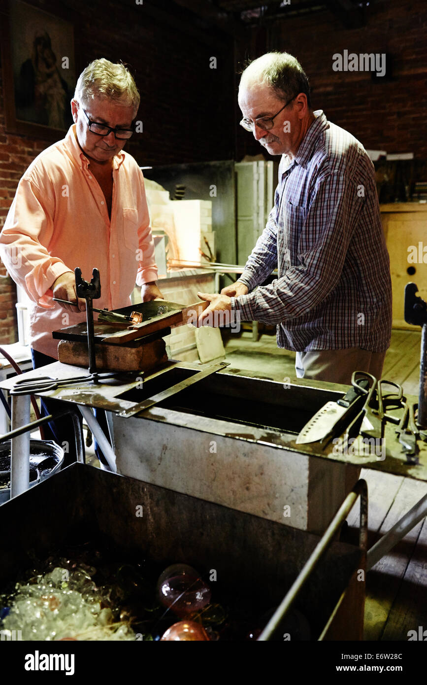 Glassmakers, Glassblowers forming molten glass, glass factory, Ajeto ...