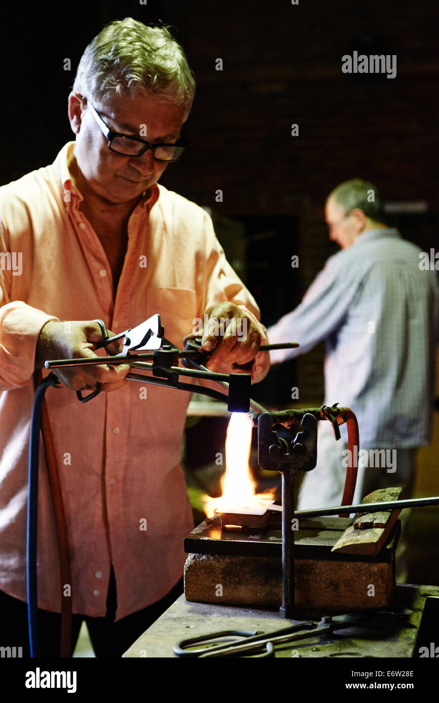 Glassmakers, Glassblowers forming molten glass, glass factory, Ajeto ...