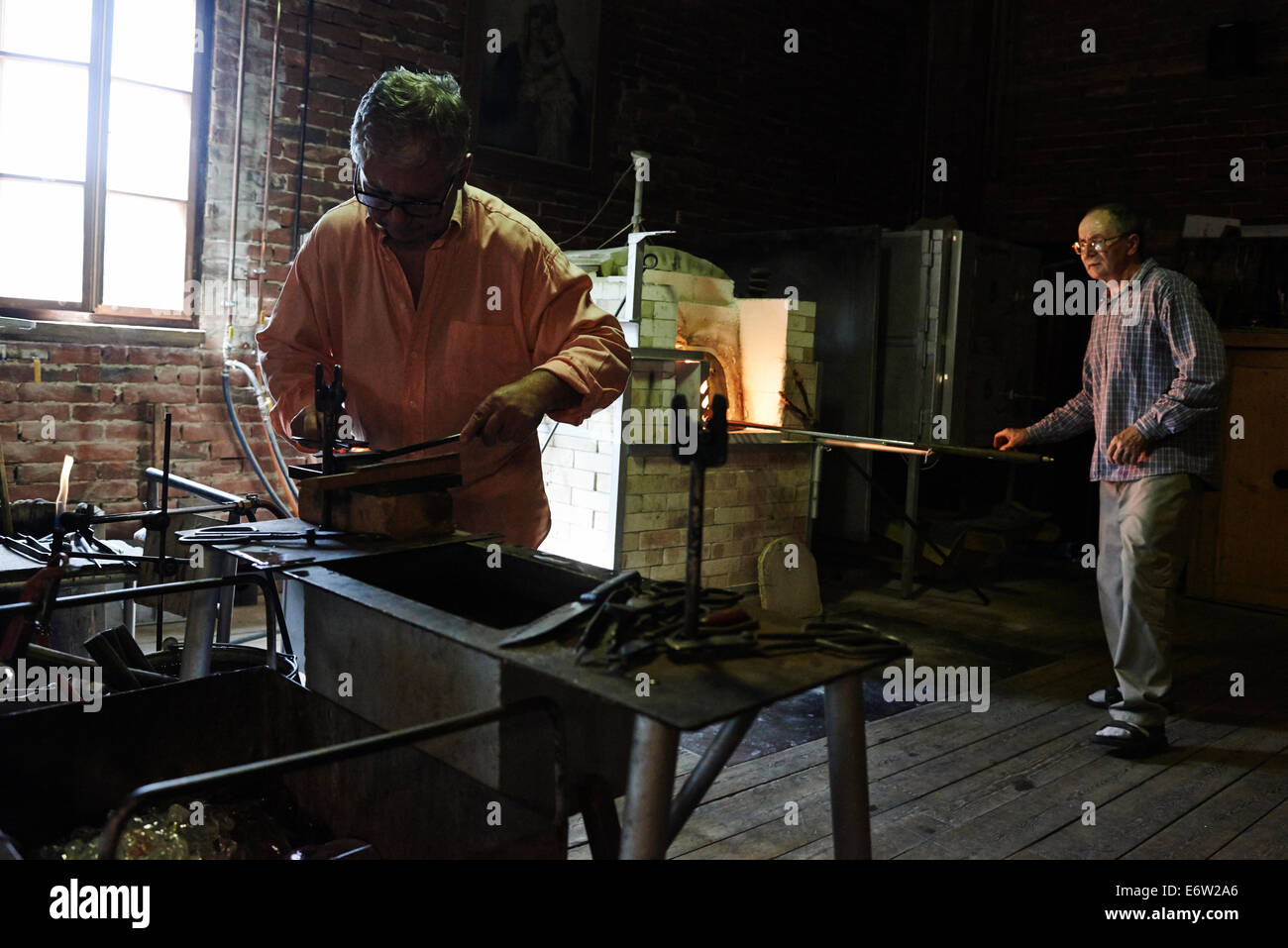 Glassmakers, Glassblowers forming molten glass, glass factory, Ajeto ...