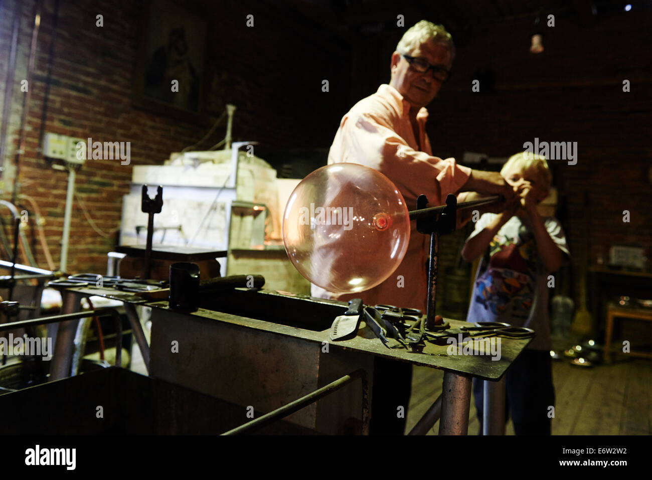 Glassmakers, Glassblowers forming molten glass, glass factory, Ajeto ...