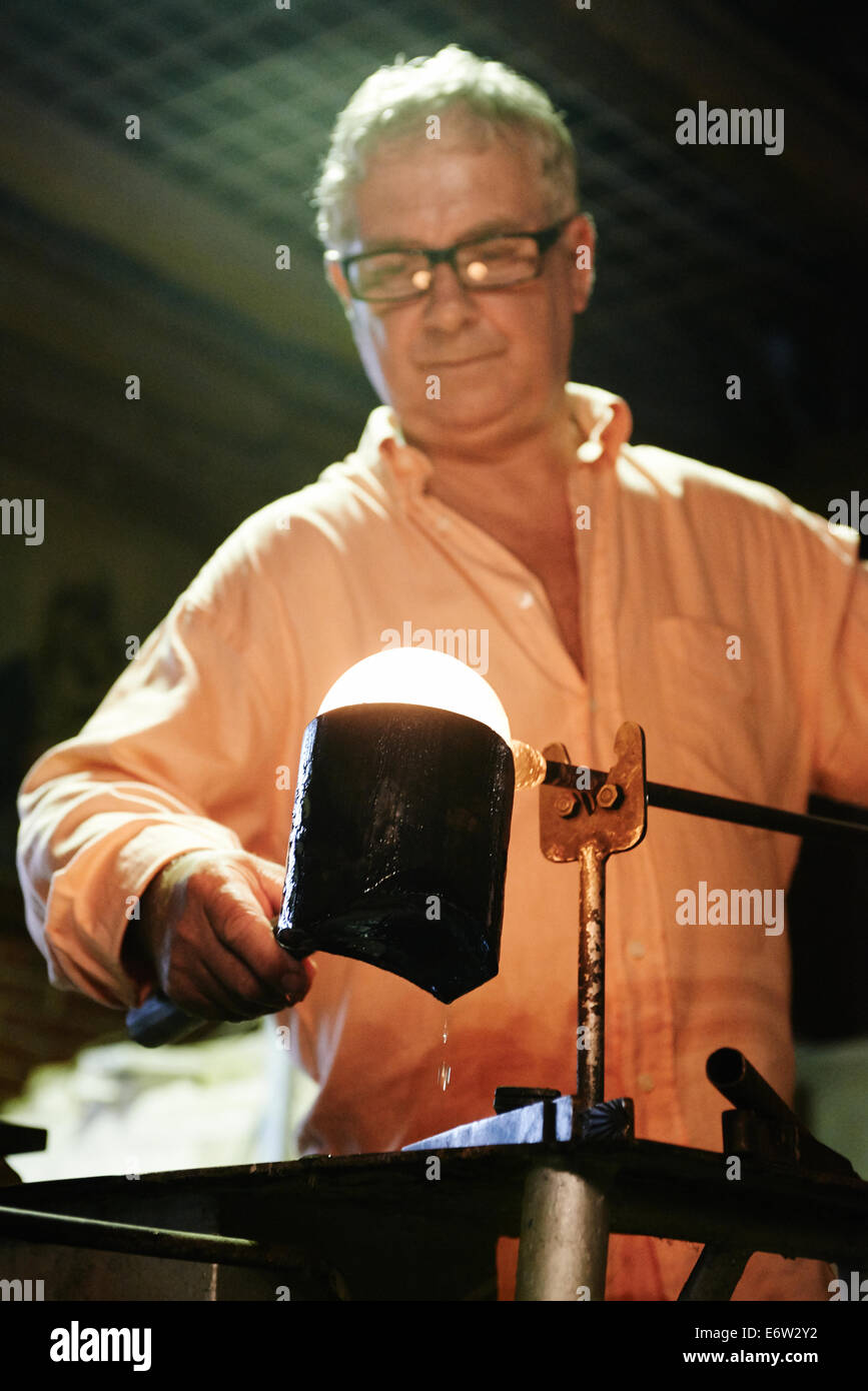 Glassmakers, Glassblowers forming molten glass, glass factory, Ajeto ...