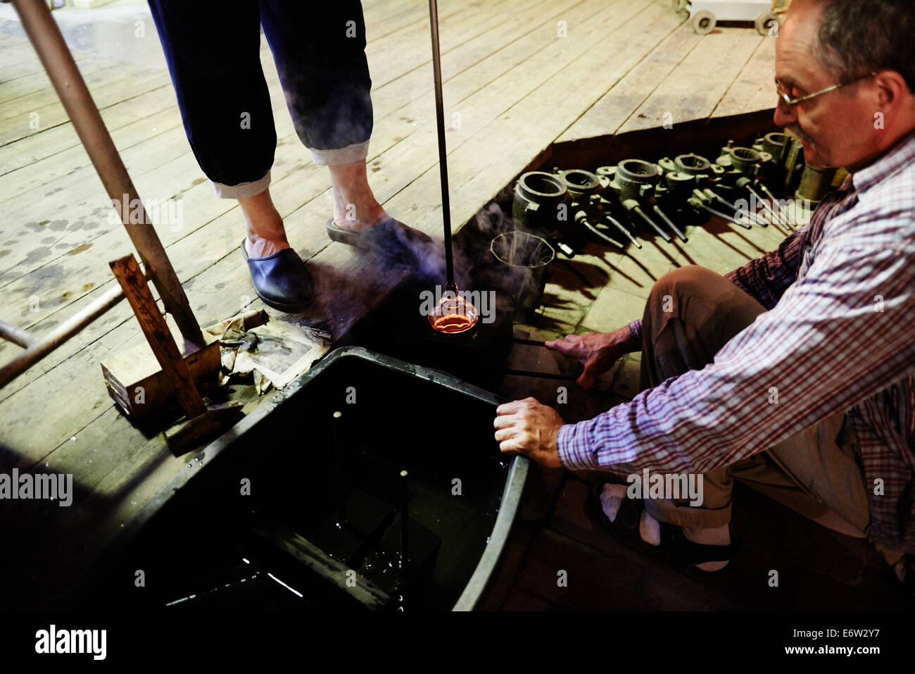 Glassmakers, Glassblowers forming molten glass, glass factory, Ajeto ...