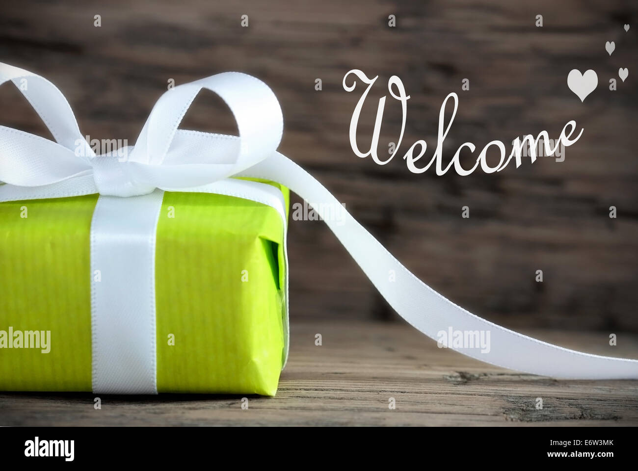 Green Gift with White Ribbon and the Word Welcome Stock Photo - Alamy