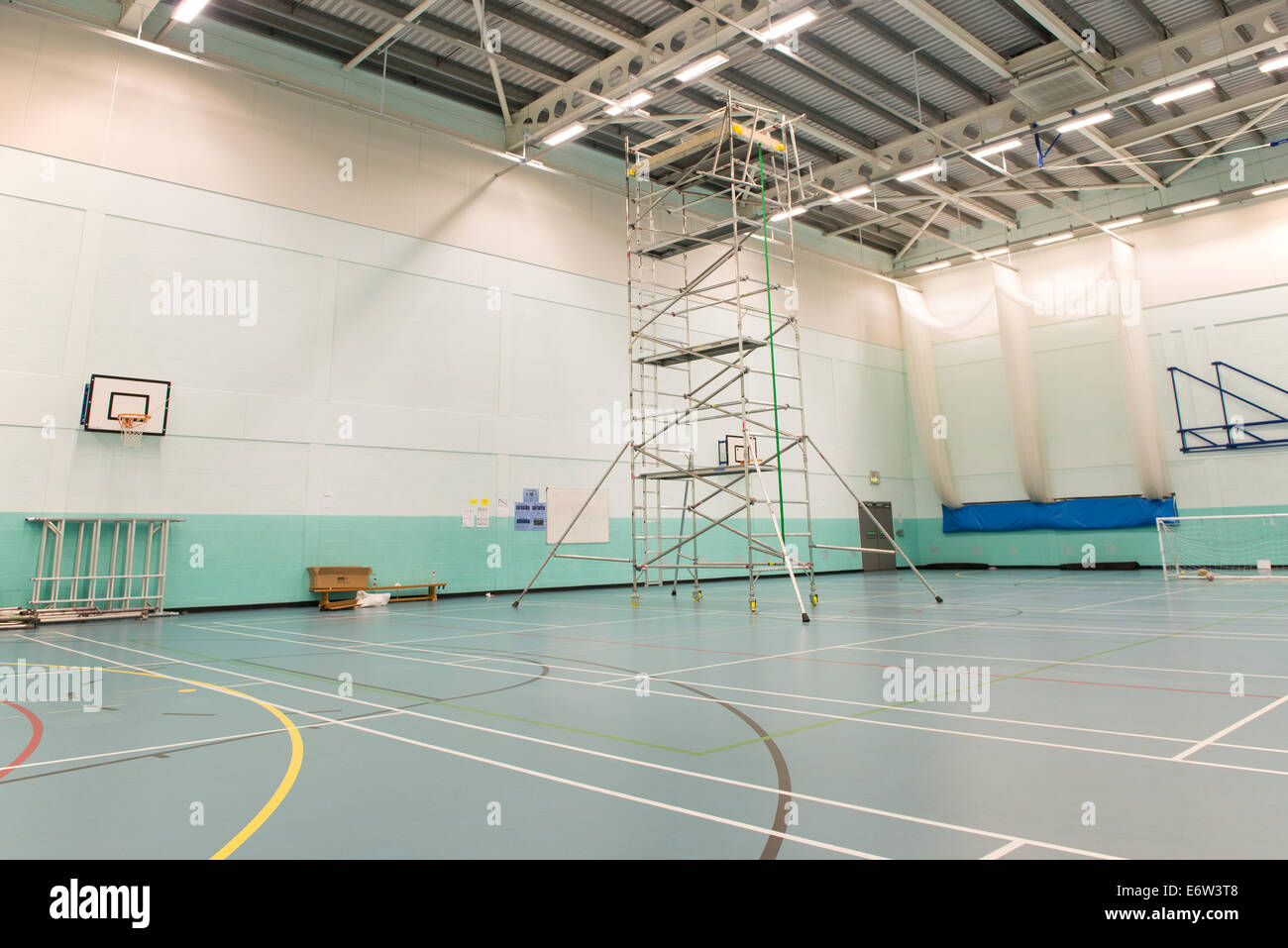 High level scaffolding tower in an empty sports hall Stock Photo - Alamy