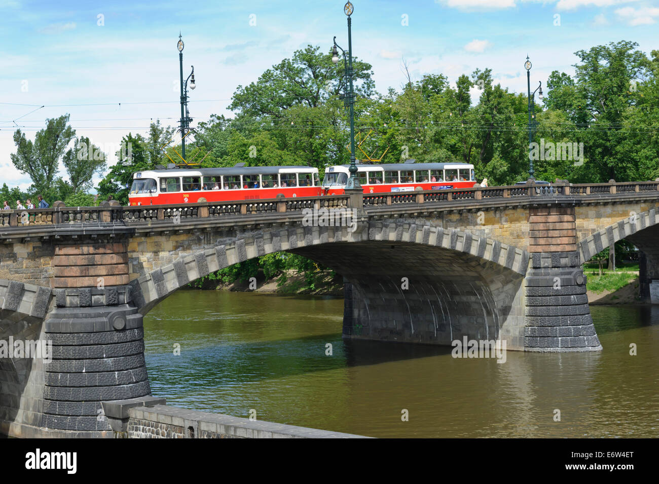 A traditional electric tram crossing one of the historic bridges in the ...