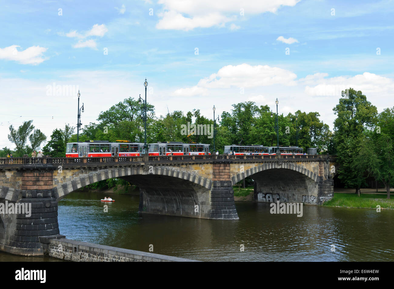A traditional electric tram crossing one of the historic bridges in the ...