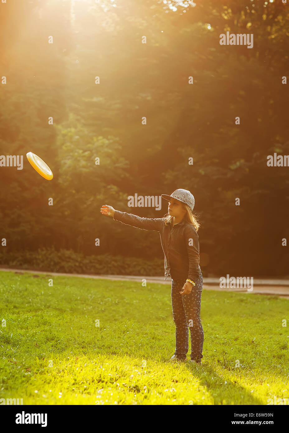girl spend a fun time at the park playing frisbee plate Stock Photo - Alamy