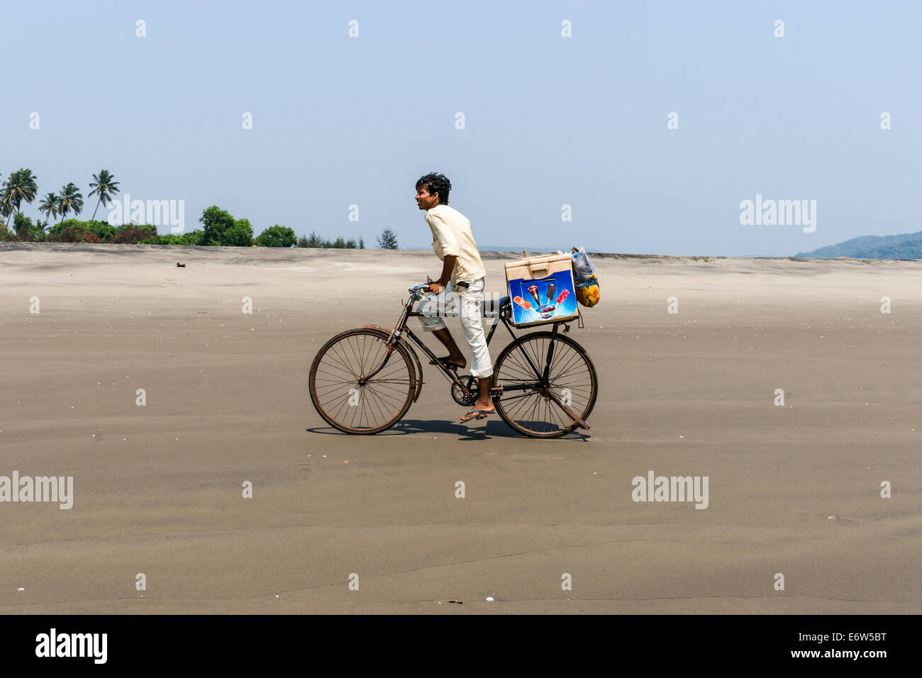 Ice cream vendor riding his bicycle on Morjim beach, Goa Stock Photo ...