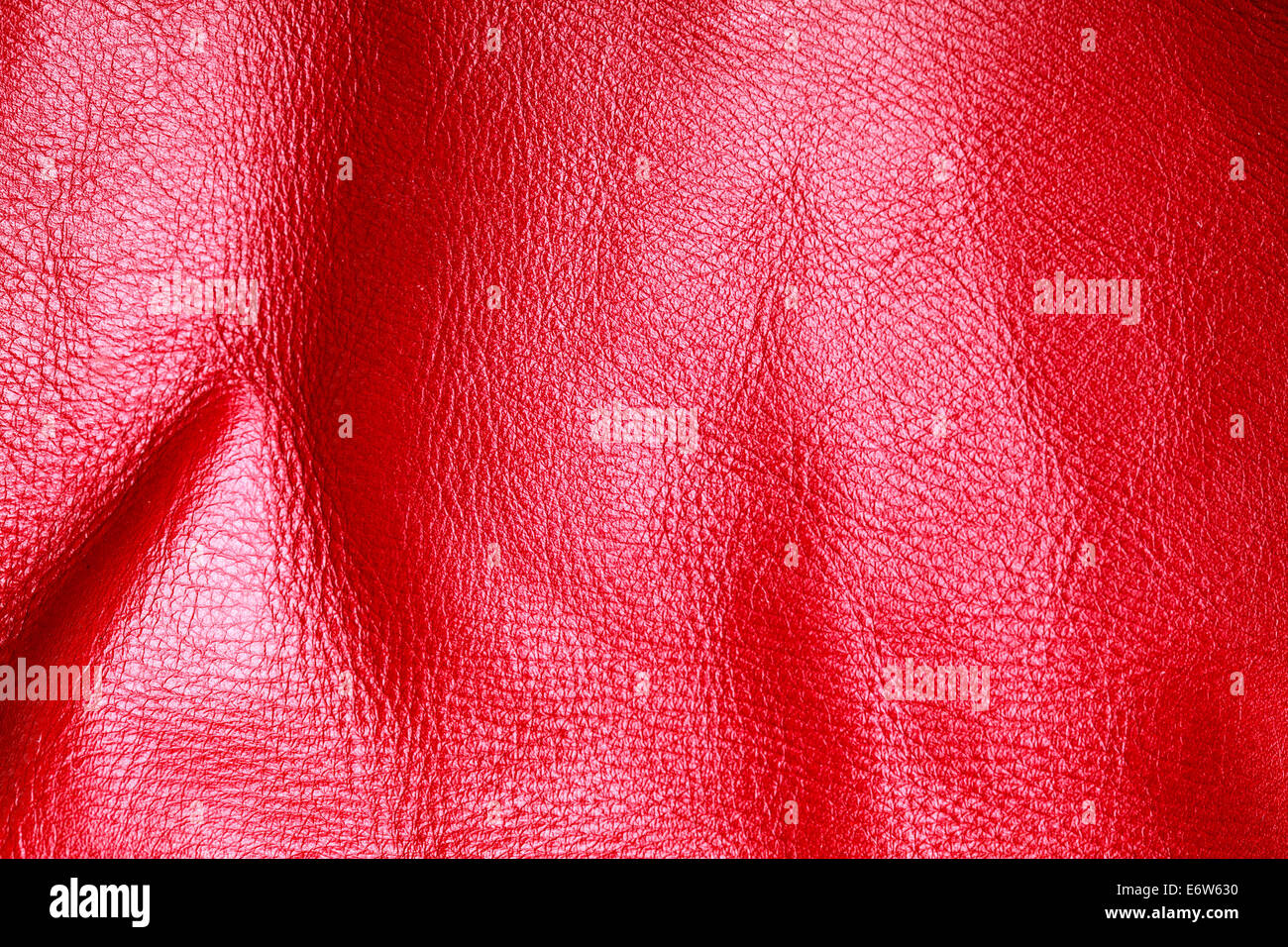 Red leather texture background closeup. Folds wavy natural skin ...