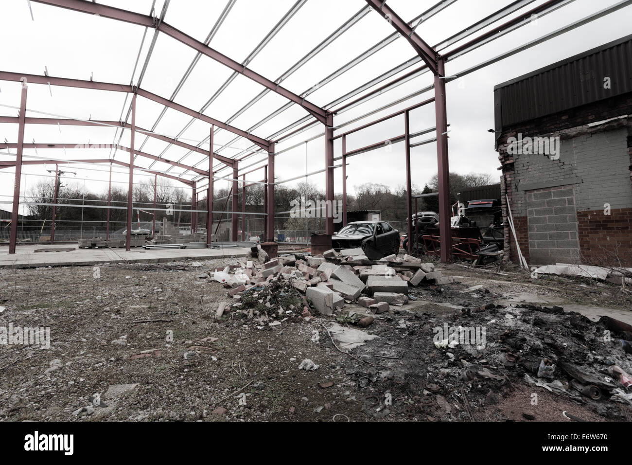 Abandoned construction project steel beams bricks rubble desaturated ...