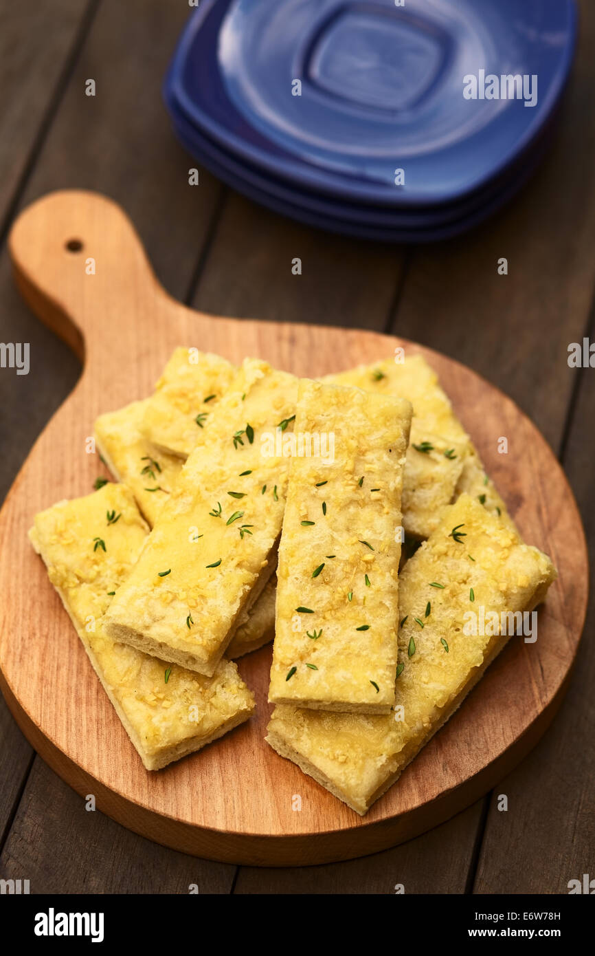 Fresh homemade garlic and cheese sticks made of a yeast dough served on ...