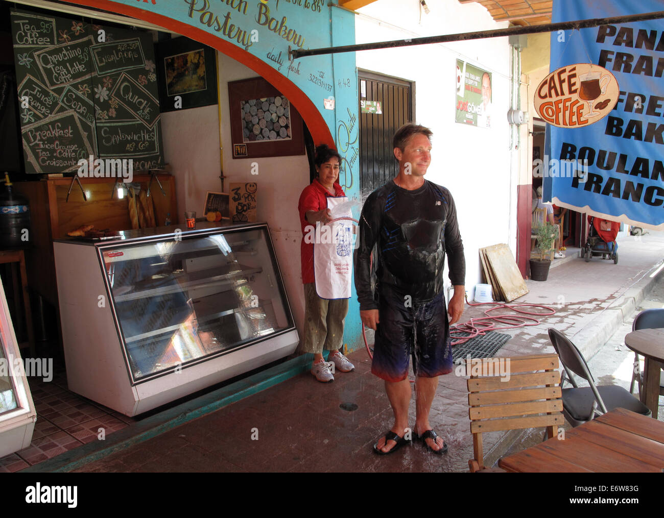 Man getting hosed down with water on a hot summer day Stock Photo - Alamy