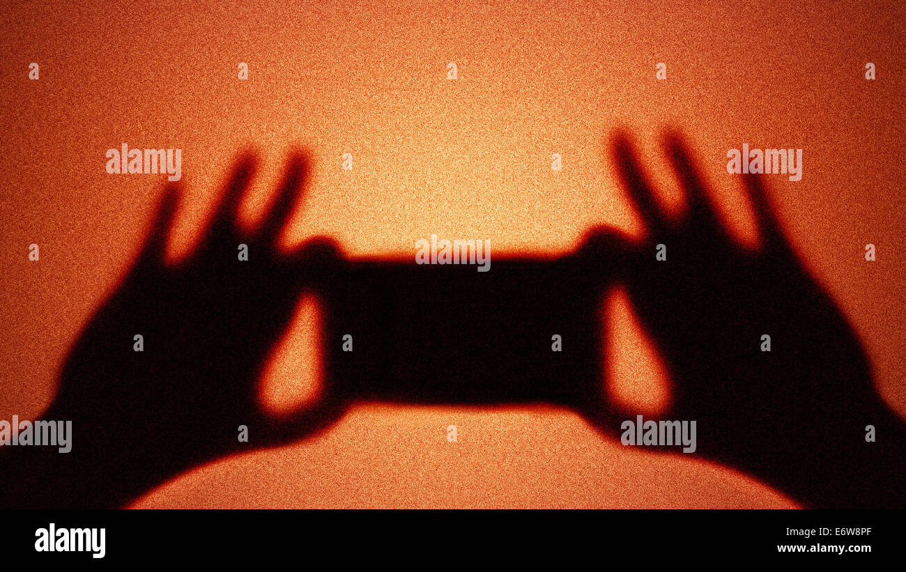 Shadow of smartphone photographer on spotlight illuminated grainy ...