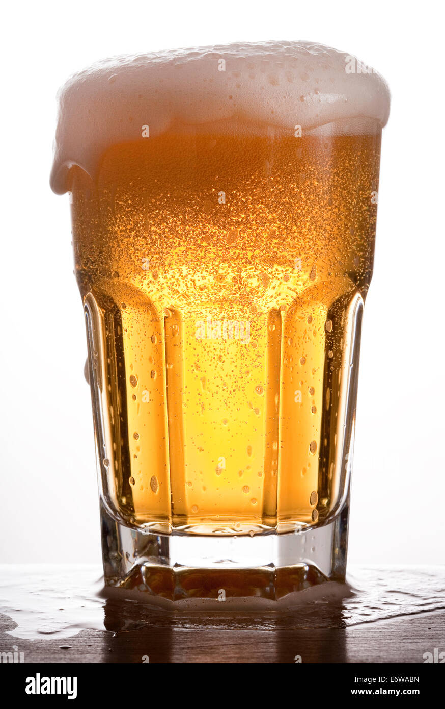 Glass of brimming beer Stock Photo - Alamy