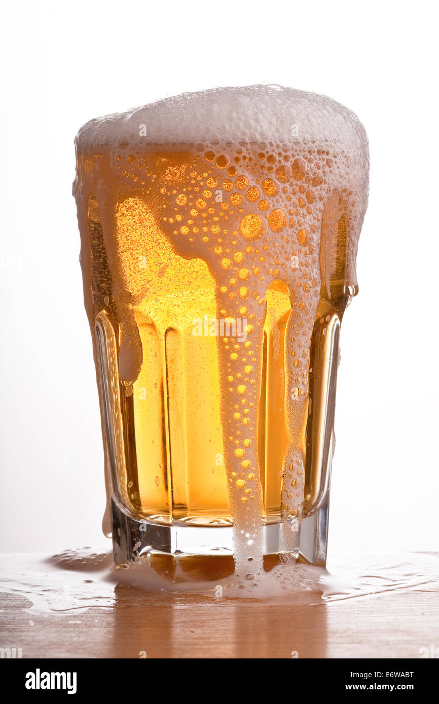 Glass of brimming beer Stock Photo - Alamy