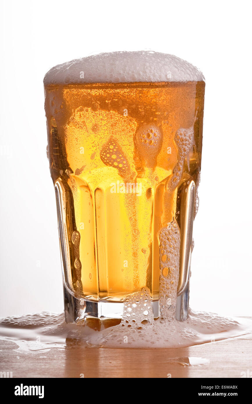 Glass of brimming beer Stock Photo - Alamy