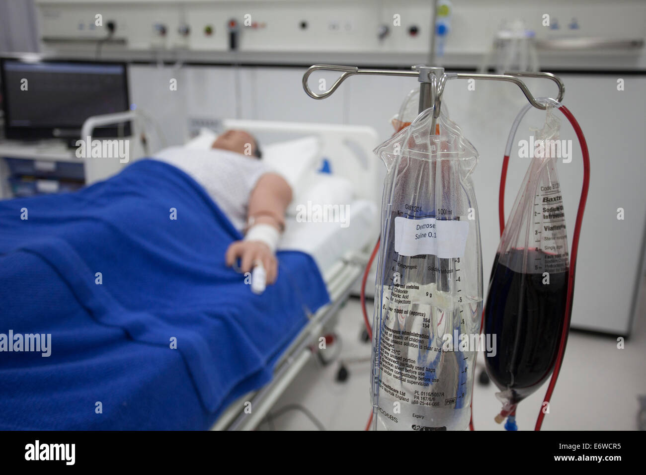 IV fluid stand with metiman simulator in background Stock Photo - Alamy