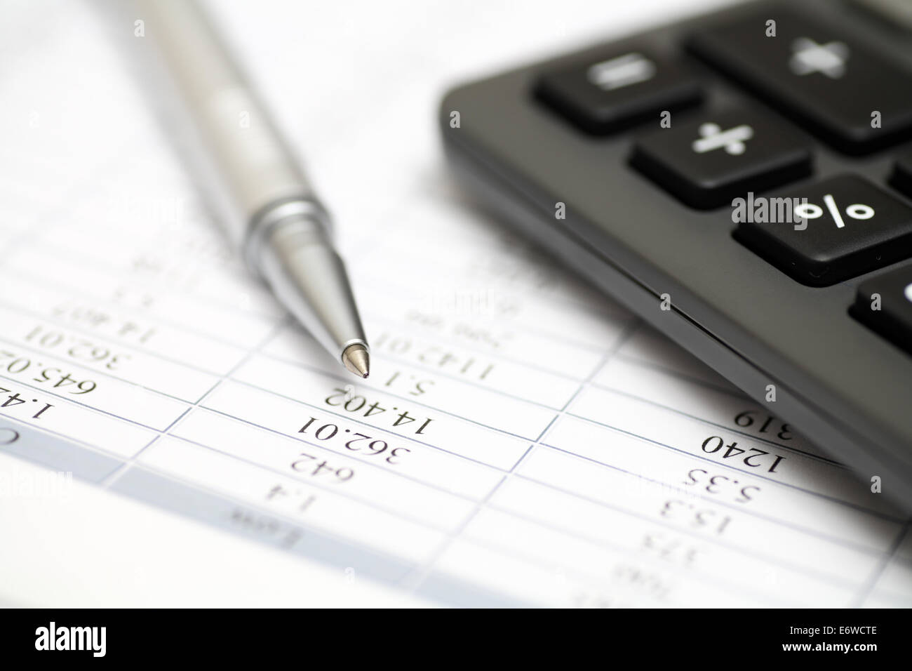 Calculator, ballpoint pen on financial statements. SDOF. Closeup Stock ...