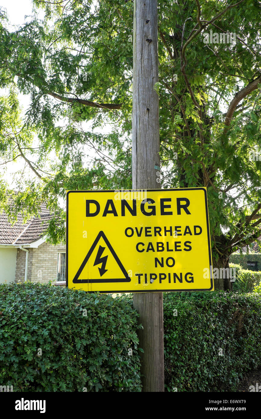 Danger Yellow road sign warning chippings tipper lorry of overhead ...