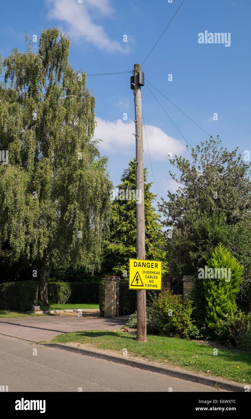 Danger Yellow road sign warning chippings tipper lorry of overhead ...