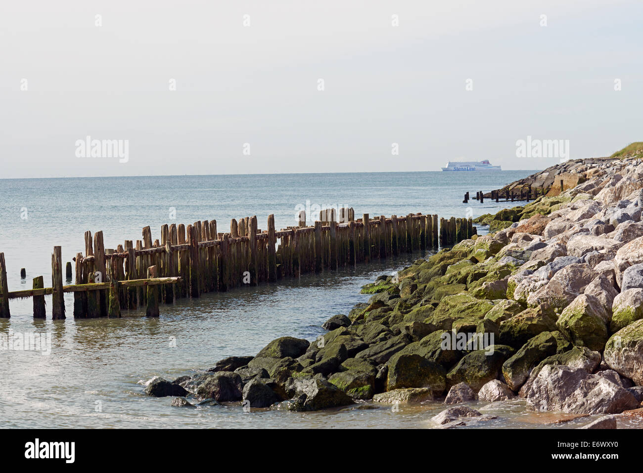 Wooden groynes & rock armour protecting the coastline from erosion at ...