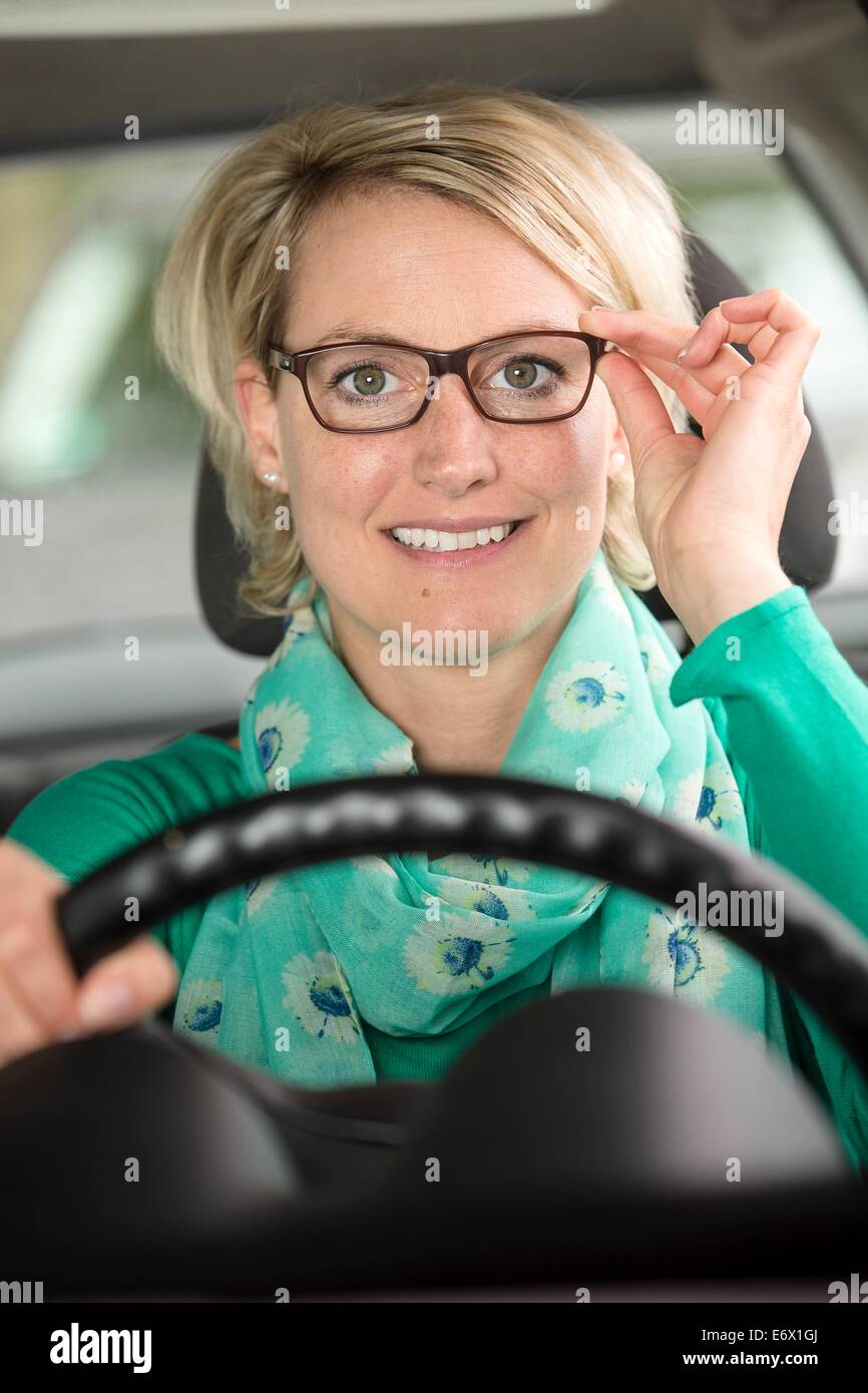 Woman wearing glasses and driving hi-res stock photography and images ...