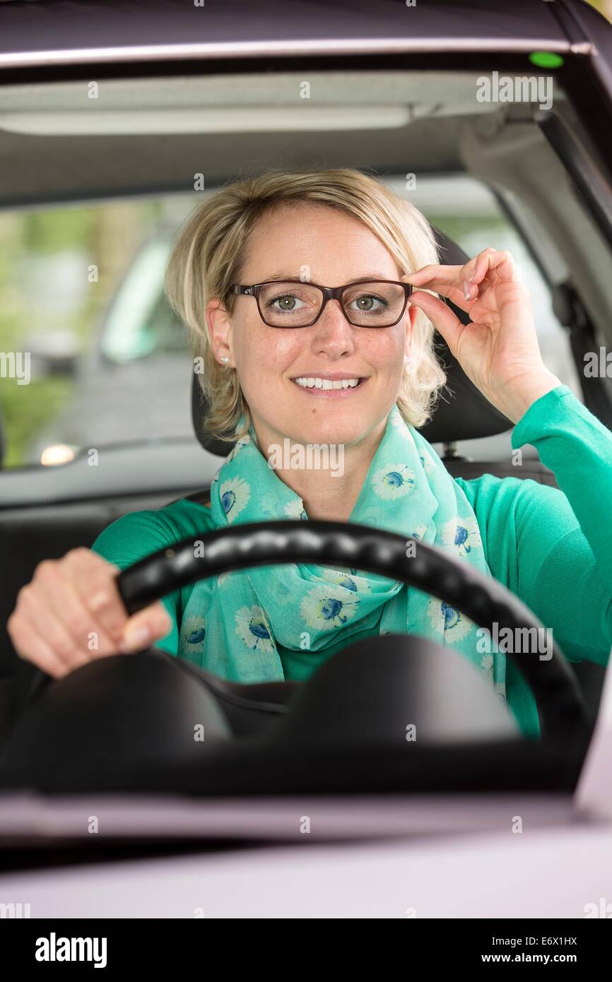 Woman wearing glasses and driving hi-res stock photography and images ...