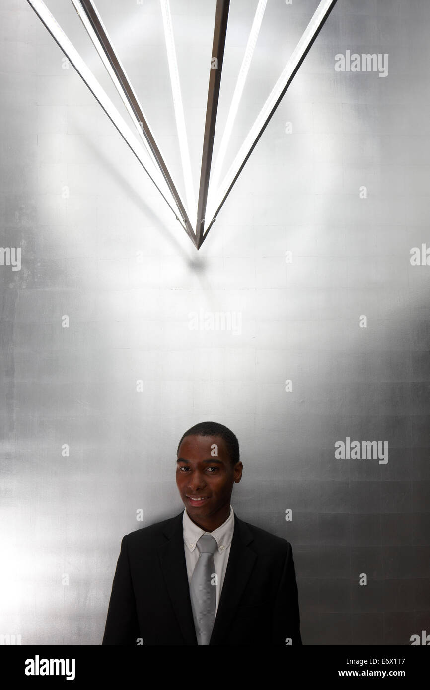 Hotel clerk in the silver hallway with walls covered in aluminium ...