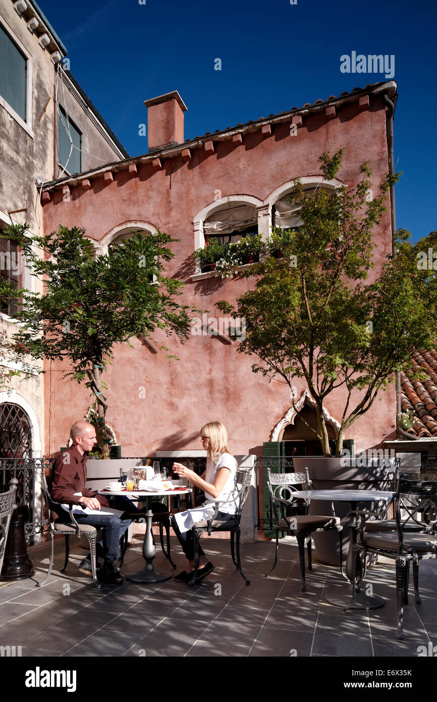 Guests having breakfast at a hotel rooftop terrace, Venice, Veneto ...