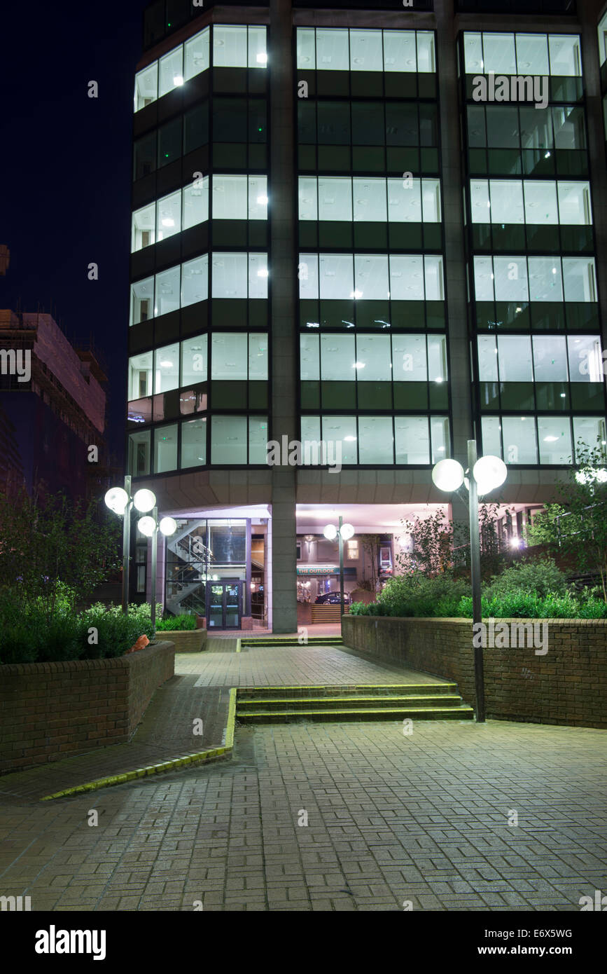 Office building and plaza lit up at night Stock Photo - Alamy