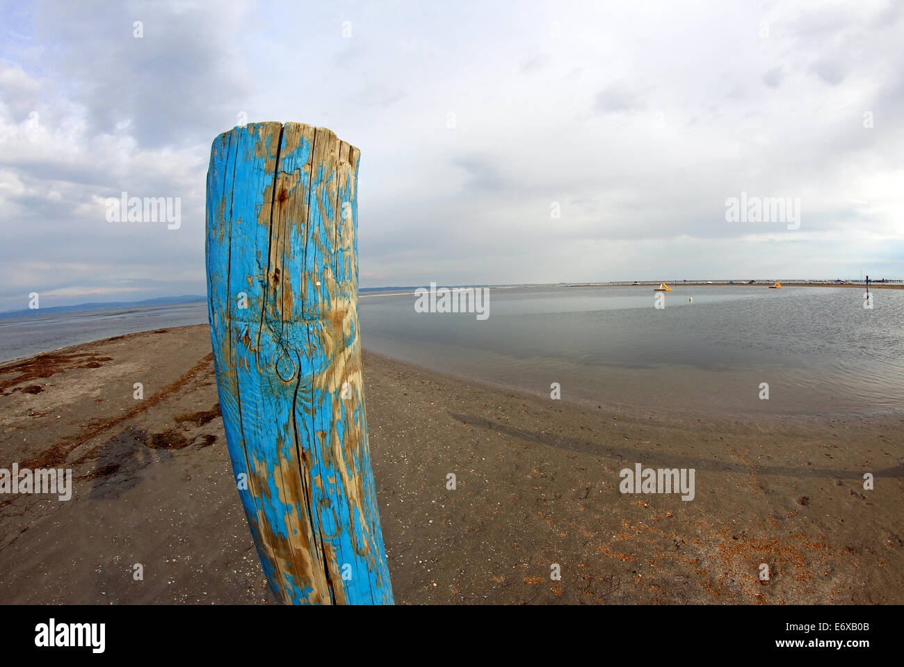 Blue pole for mooring the ships on the Sea Beach Stock Photo - Alamy