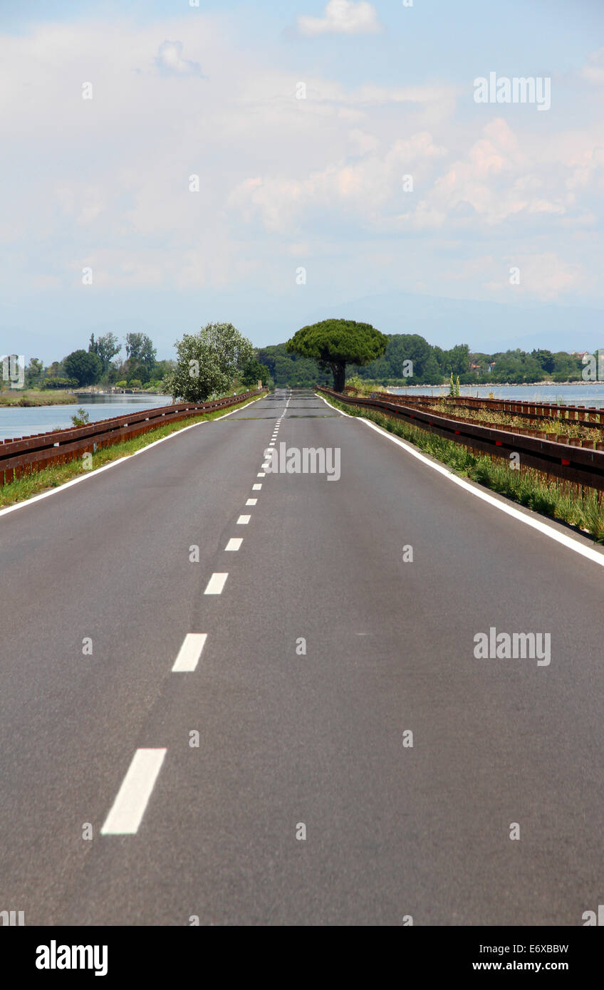 very long road in the middle of the sea with adjacent bike trail and ...