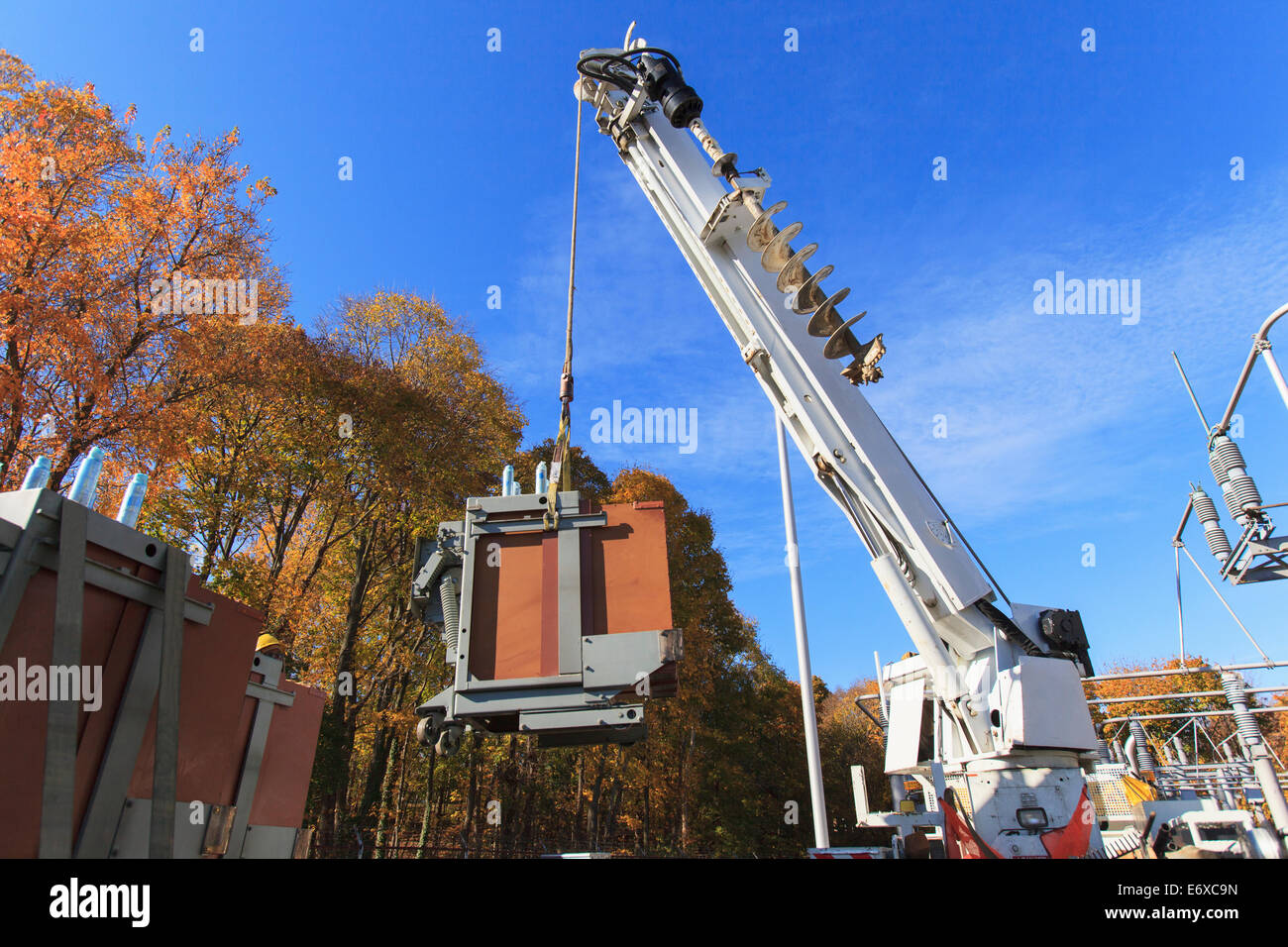 Crane moving high voltage transformers at power plant Stock Photo - Alamy