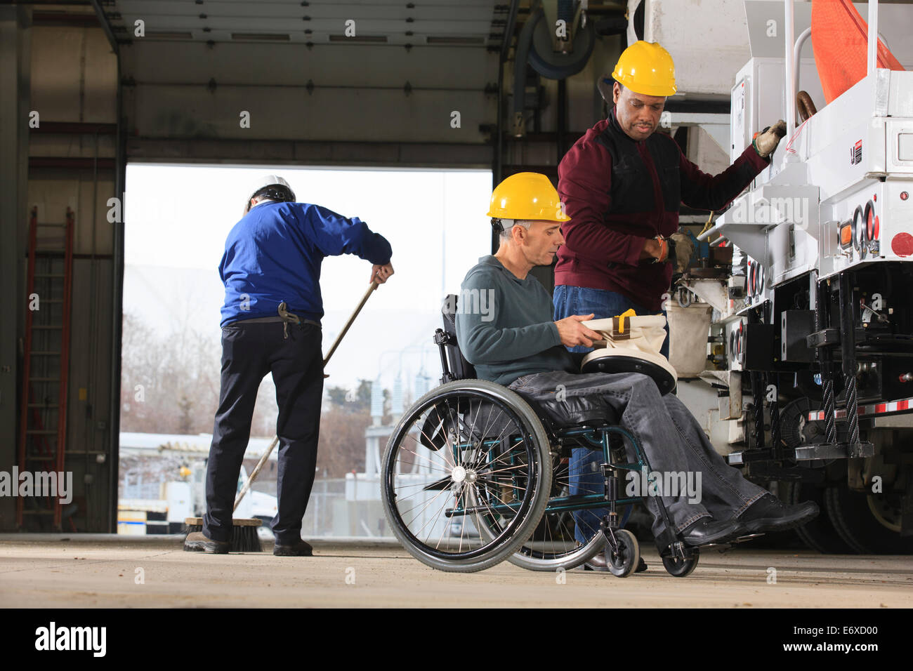 Maintenance supervisors cleaning utility garage and loading new truck ...