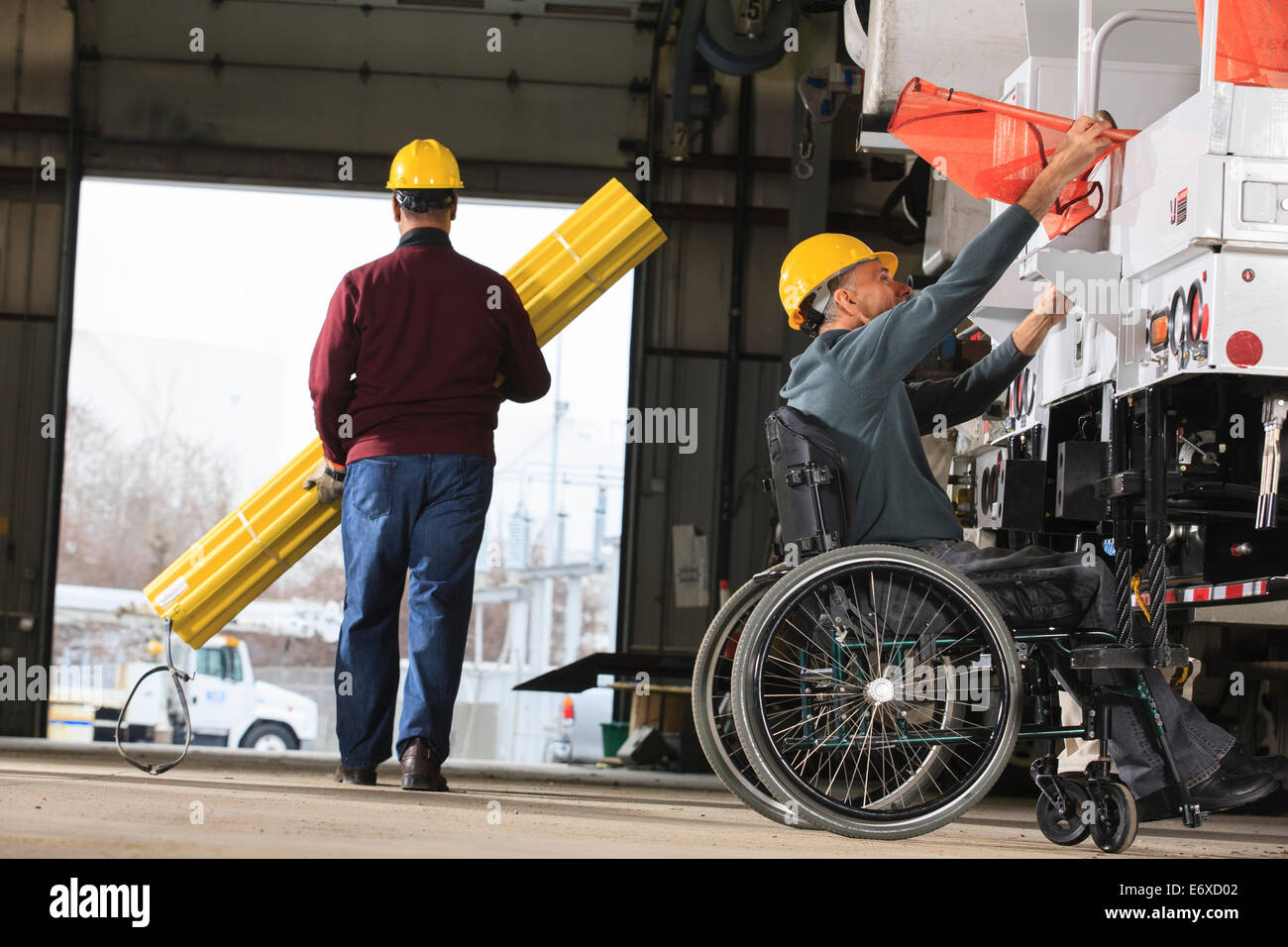 Maintenance supervisor in utility garage and loading new truck with ...