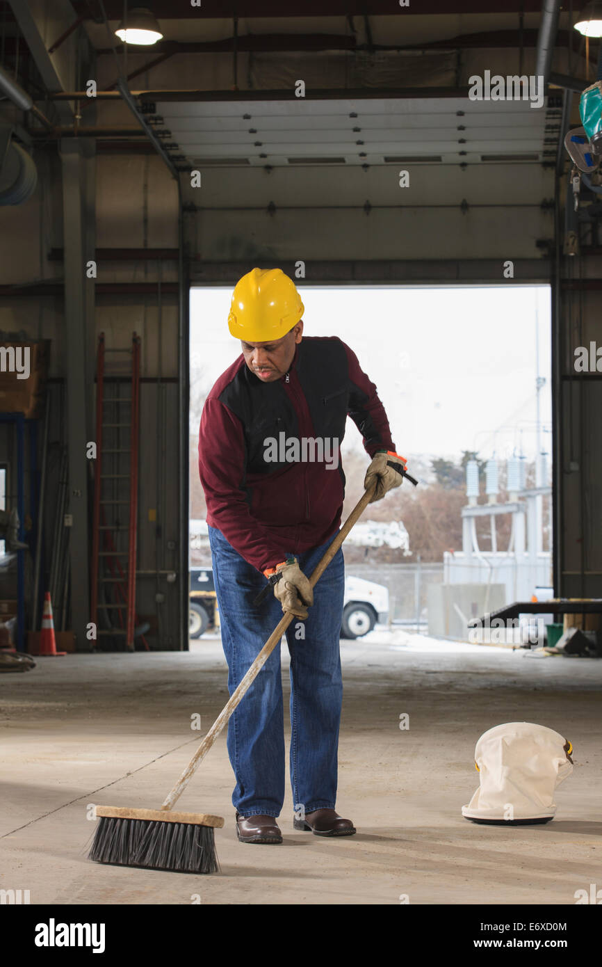 Maintenance supervisor cleaning utility garage Stock Photo - Alamy